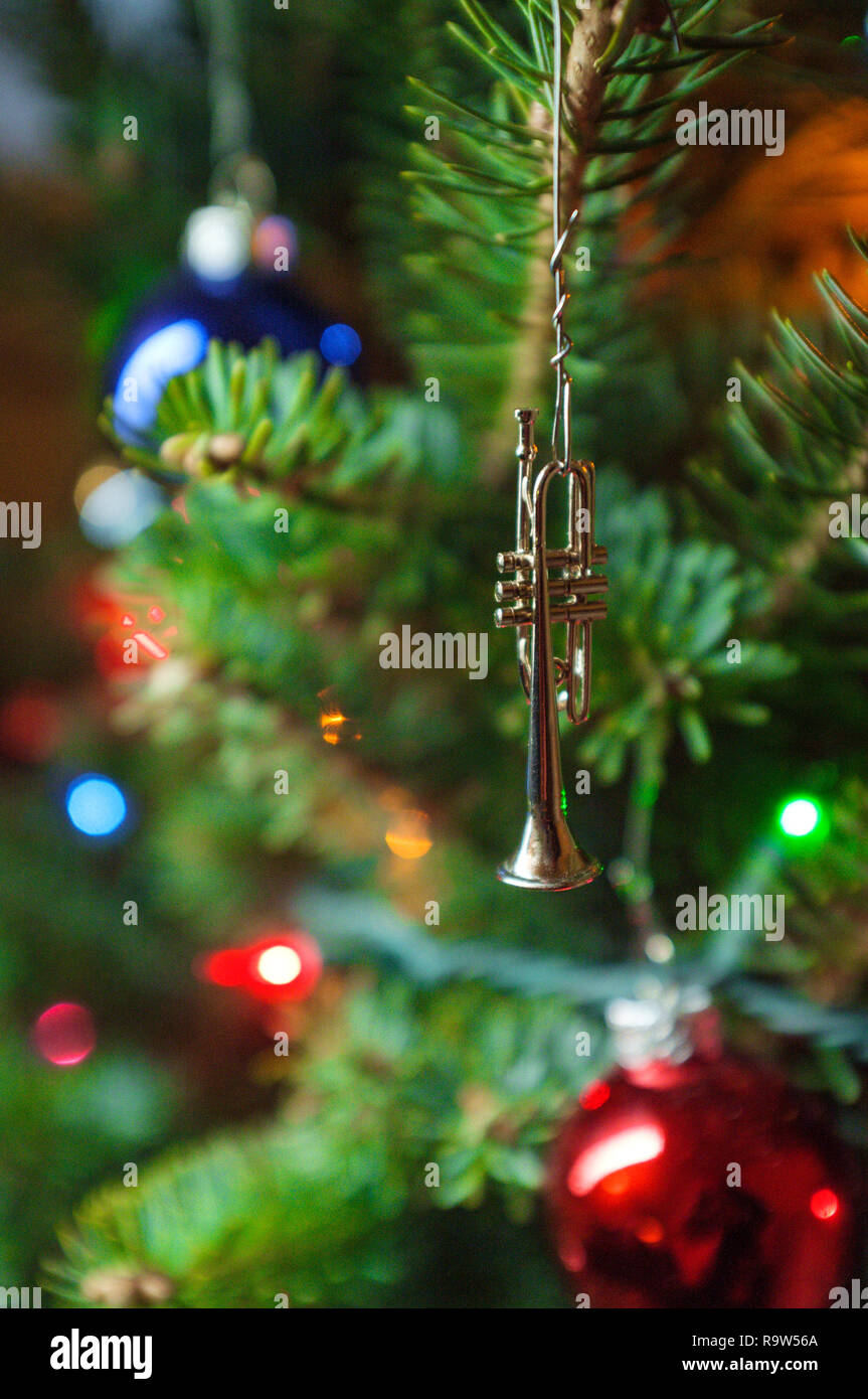 Tiny trumpet ornament decoration hangs from Christmas tree branch Stock ...