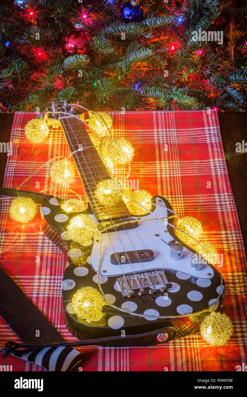 Seasonal holiday musical instrument ukulele with Christmas tree ...