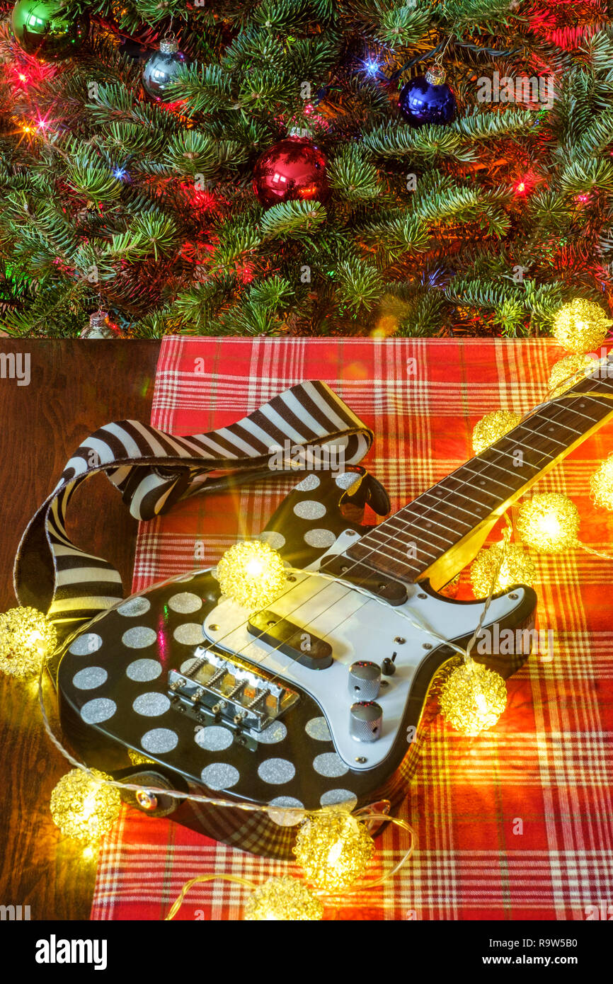 Seasonal holiday musical instrument ukulele with Christmas tree ...