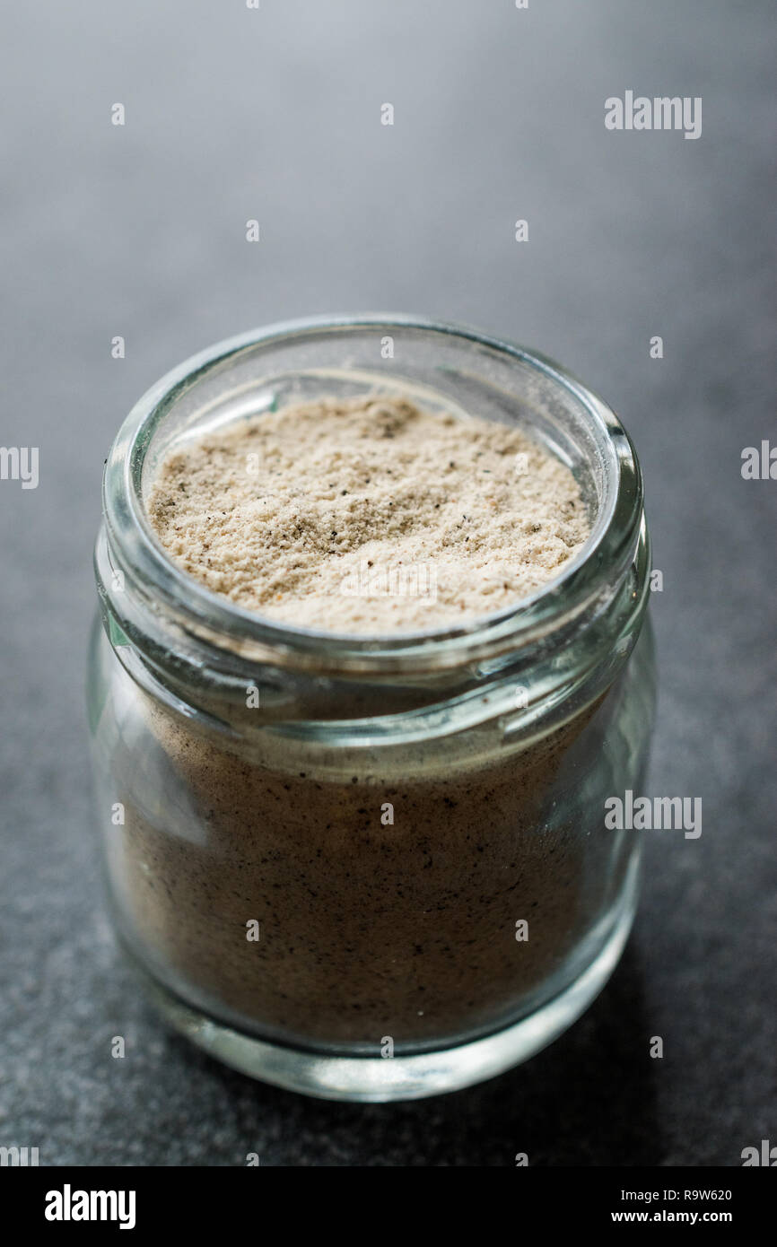White Pepper Powder in Small Glass Bowl on Grey Granit Surface. Organic ...