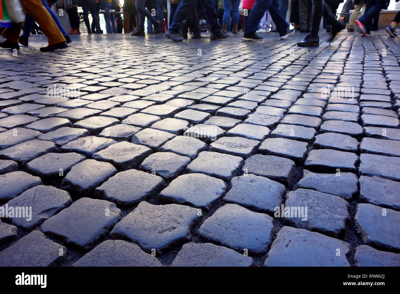 People walking on cobblestones Stock Photo - Alamy