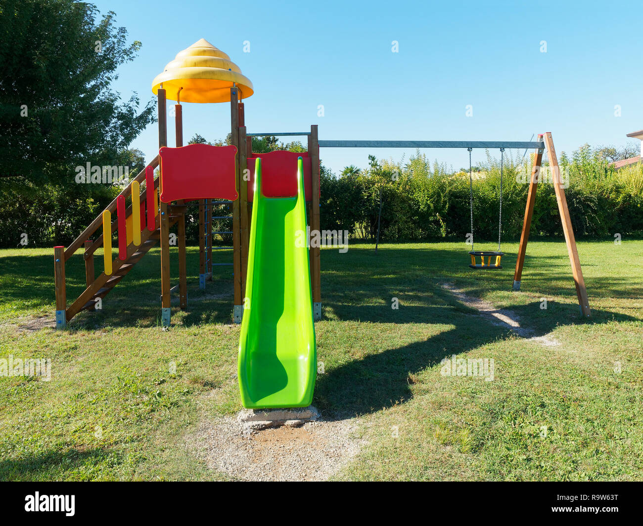 Empty slide and swing at park outdoor Stock Photo - Alamy