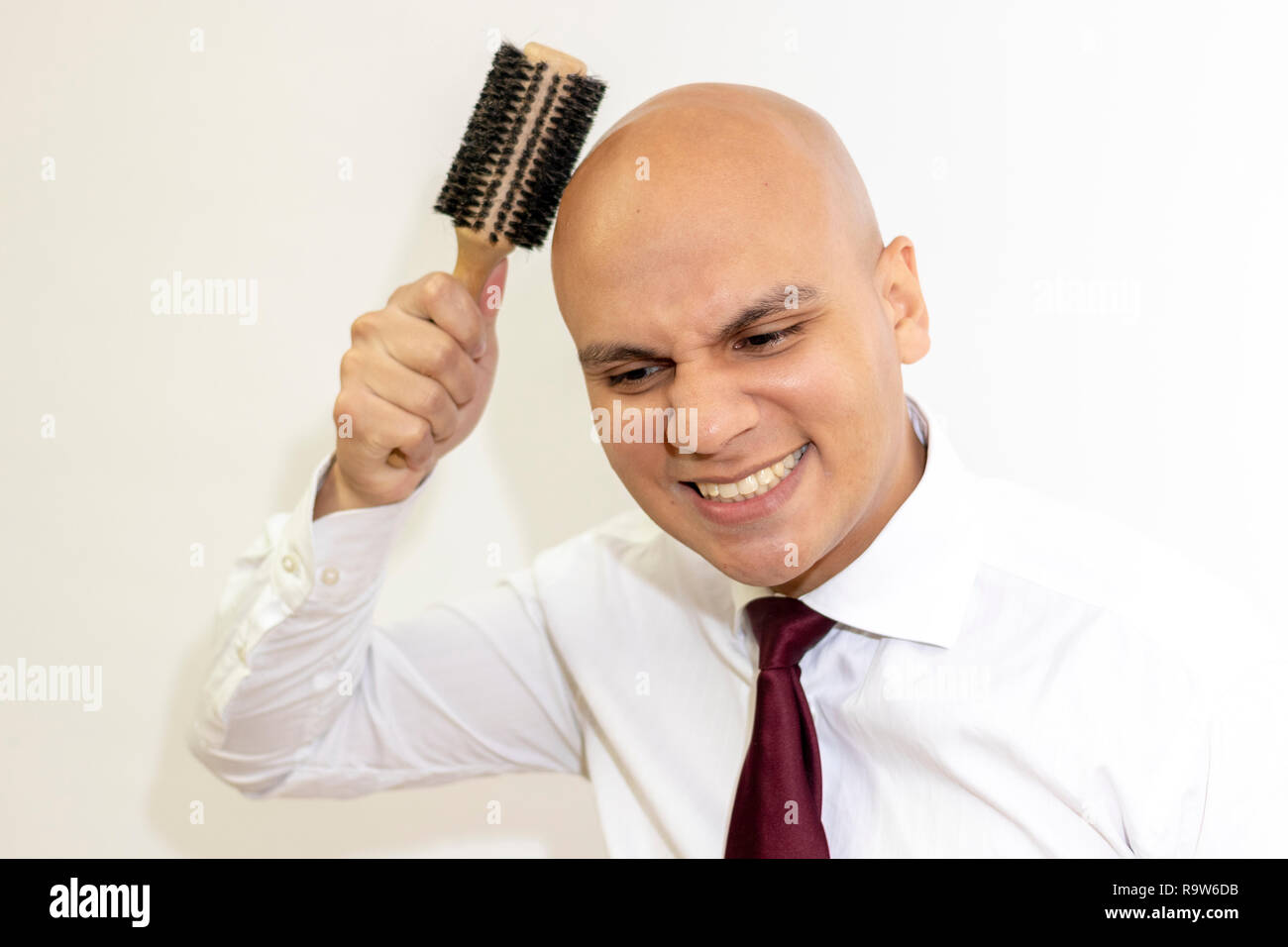 Handsome young man combing hair hi-res stock photography and images - Alamy