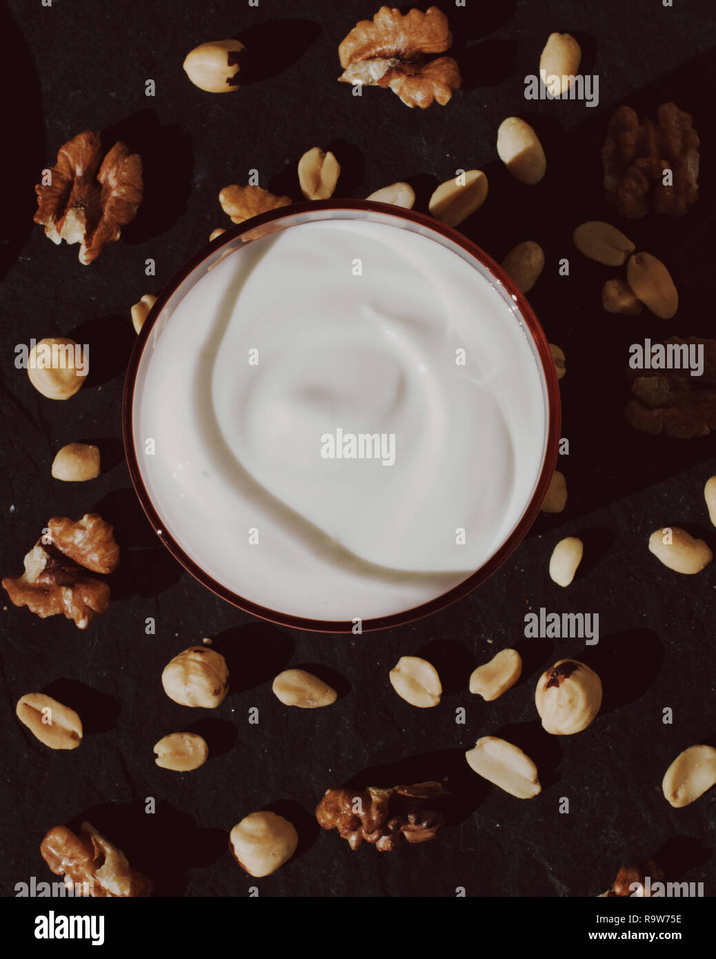 dairy and rustic farm food styled concept - fresh yogurt and nuts ...
