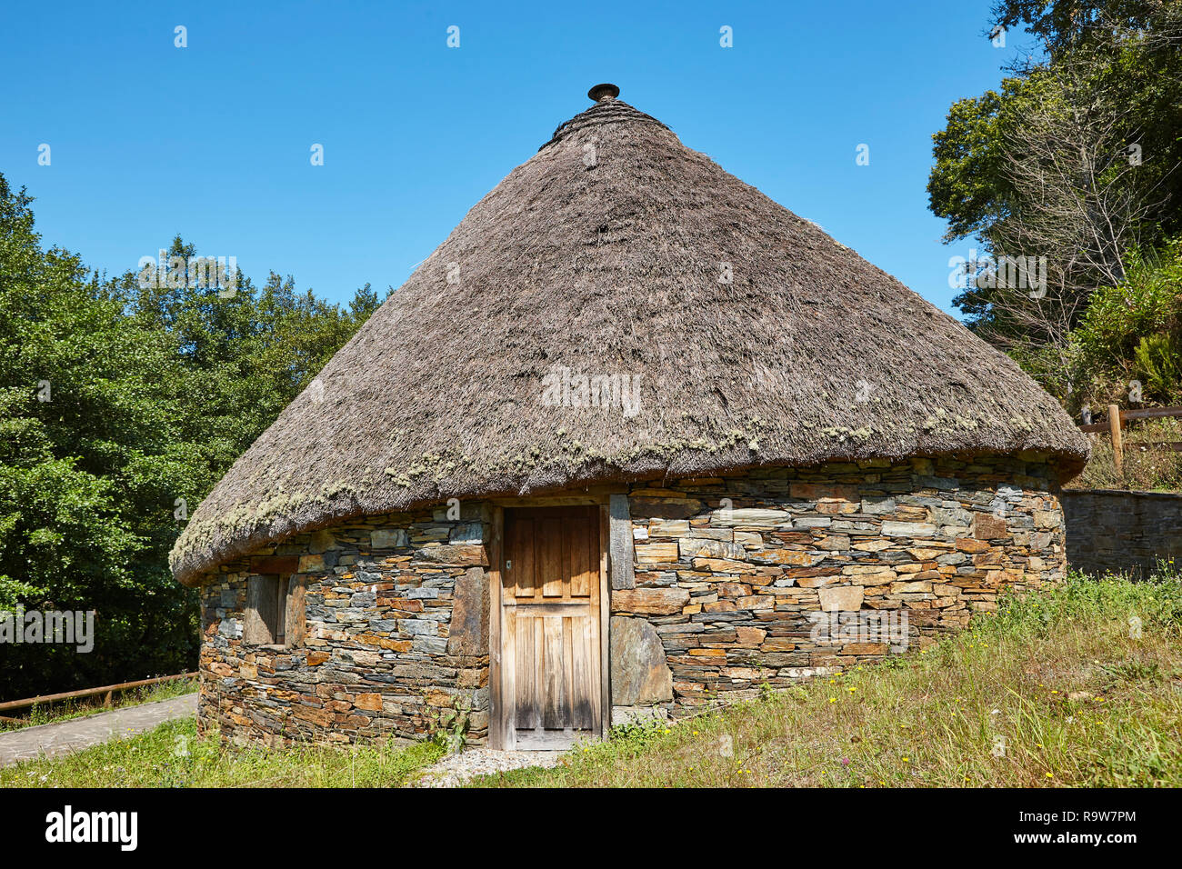 Traditional spanish construction made with stones and conical roof ...