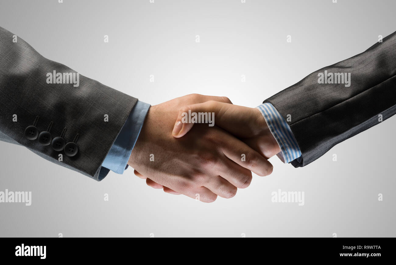 Business handshake as idea for unity and cooperation or greeting. Mixed ...