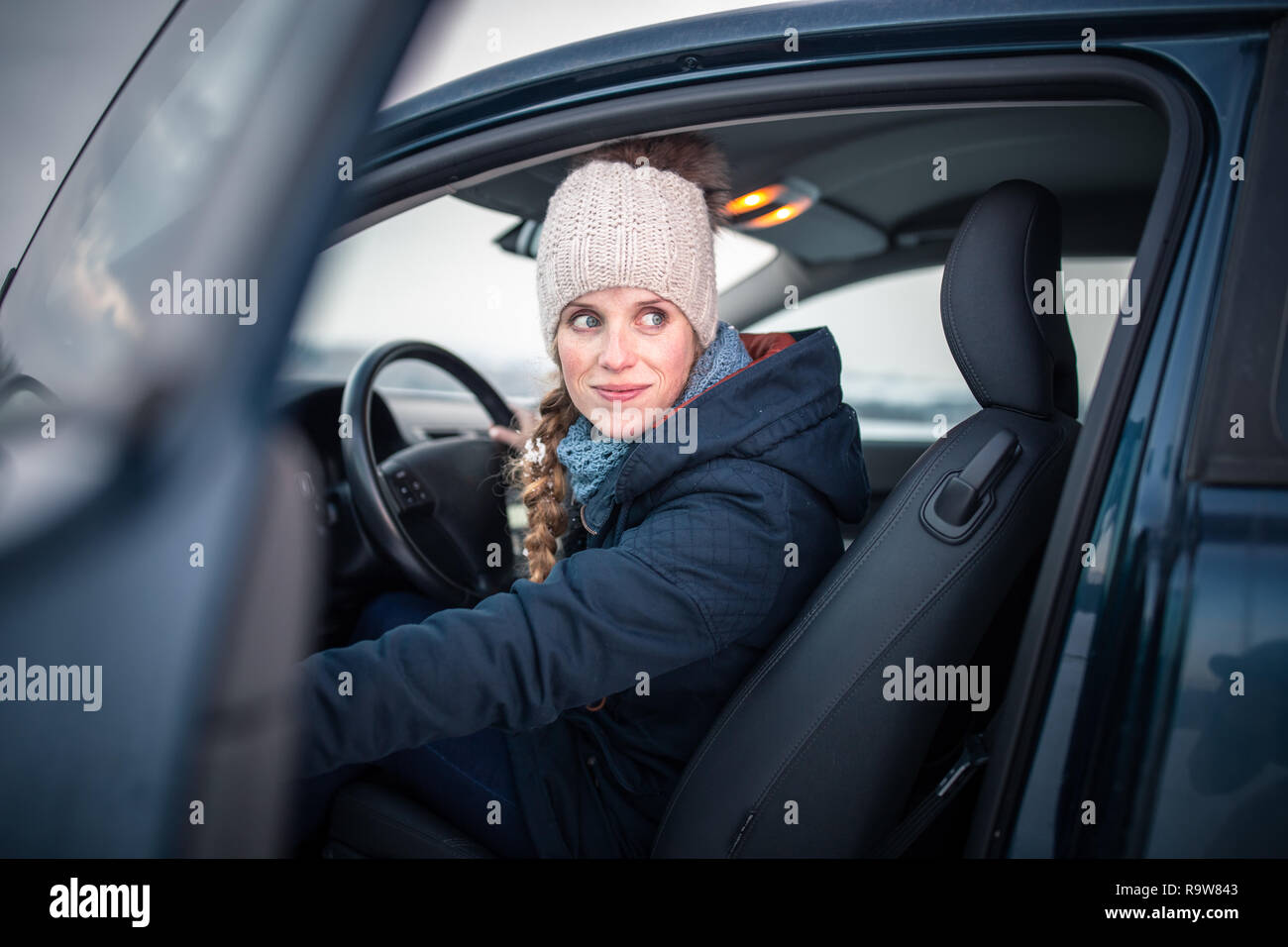 Woman driving a car - female driver at a wheel of a modern car, looking ...
