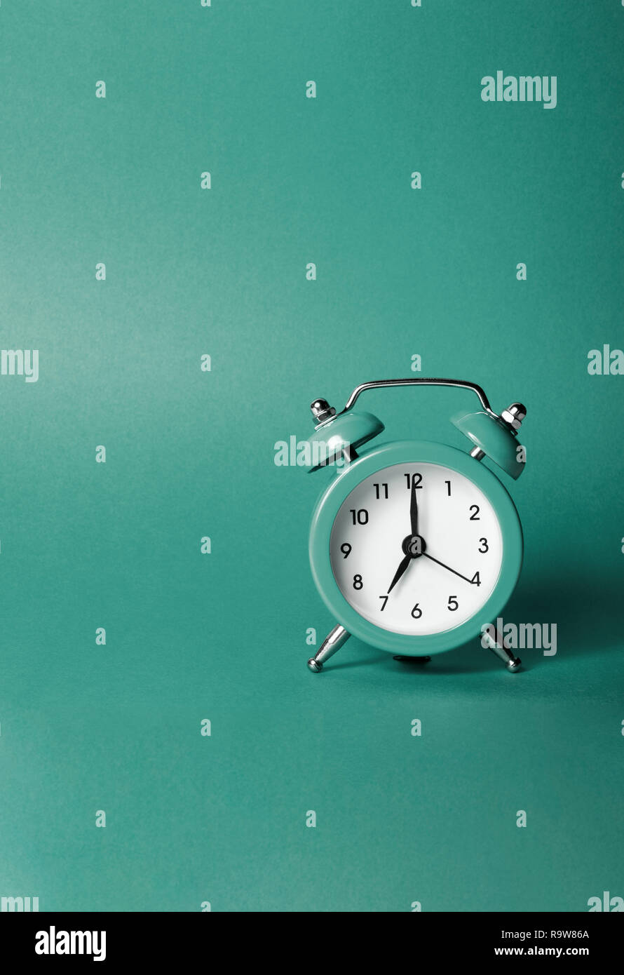 Green alarm clock on green backgrounds with space for text Stock Photo ...