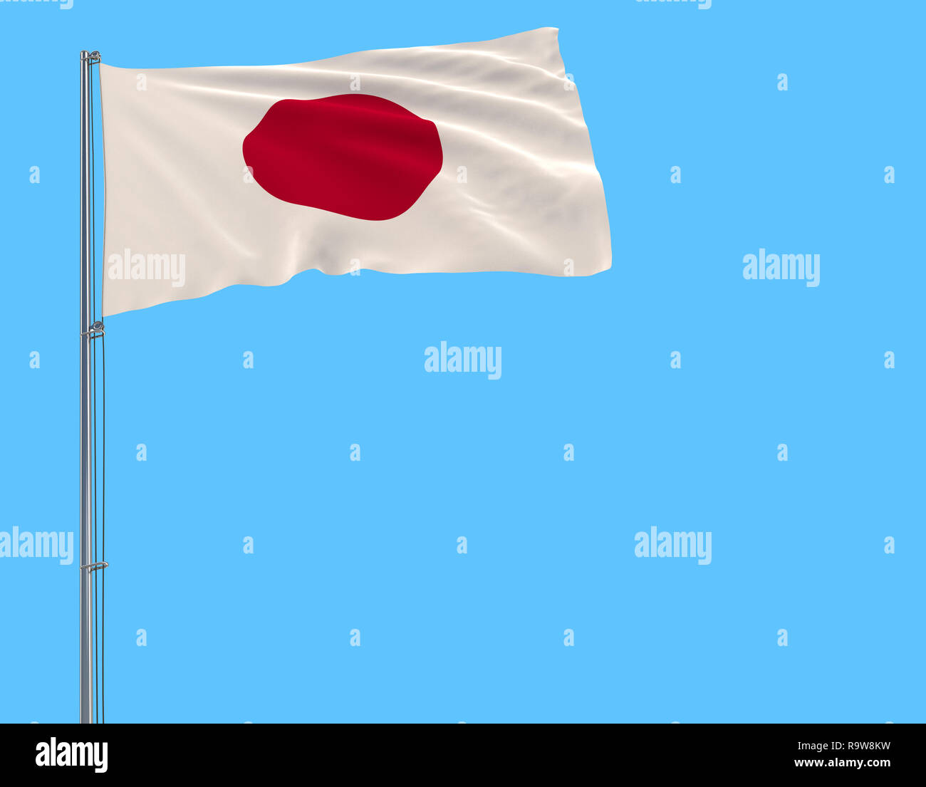 Isolate flag of Japan on a flagpole fluttering in the wind on a blue ...