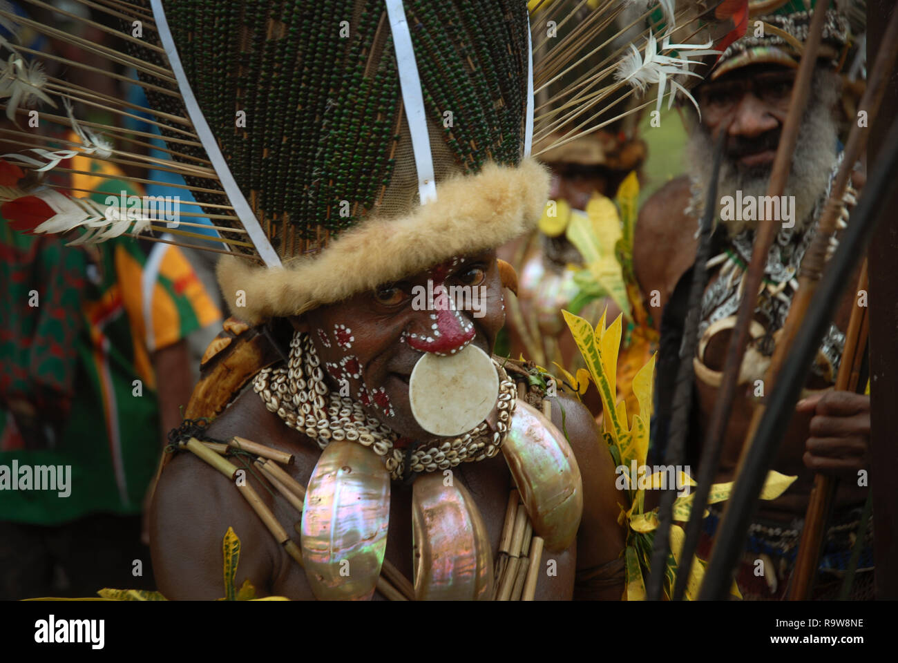 Colourfully dressed and face painted men waiting to join the annual ...