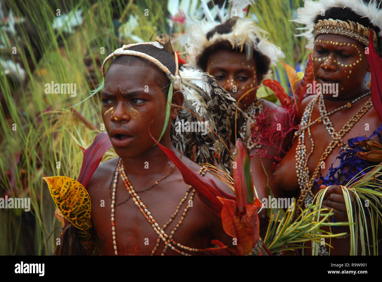 Colourfully dressed and face painted women dancing as part of the ...