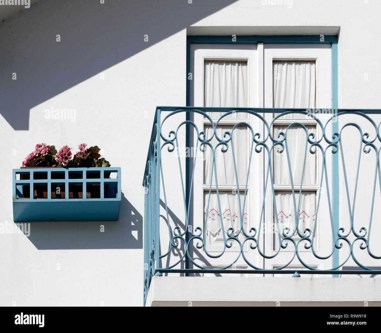 Balcony with a window and flowers of typical houses of Aveiro, Portugal ...