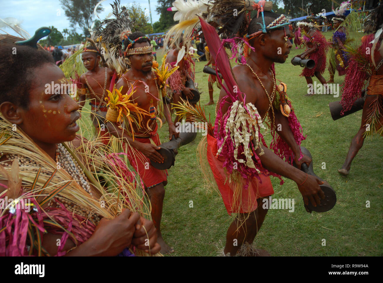 Colourfully dressed and face painted woman as part of the annual Sing ...