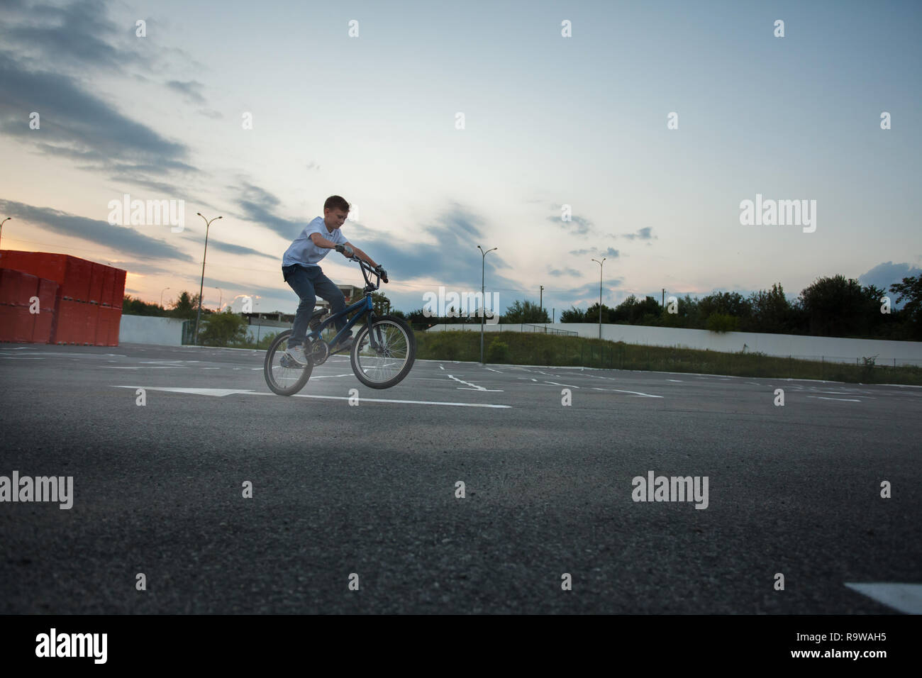 Little boy doing tricks jumping riding bike Stock Photo - Alamy
