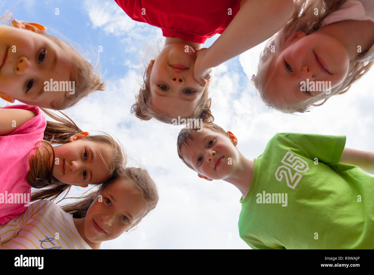 Kids standing leaning looking at the camera Stock Photo - Alamy