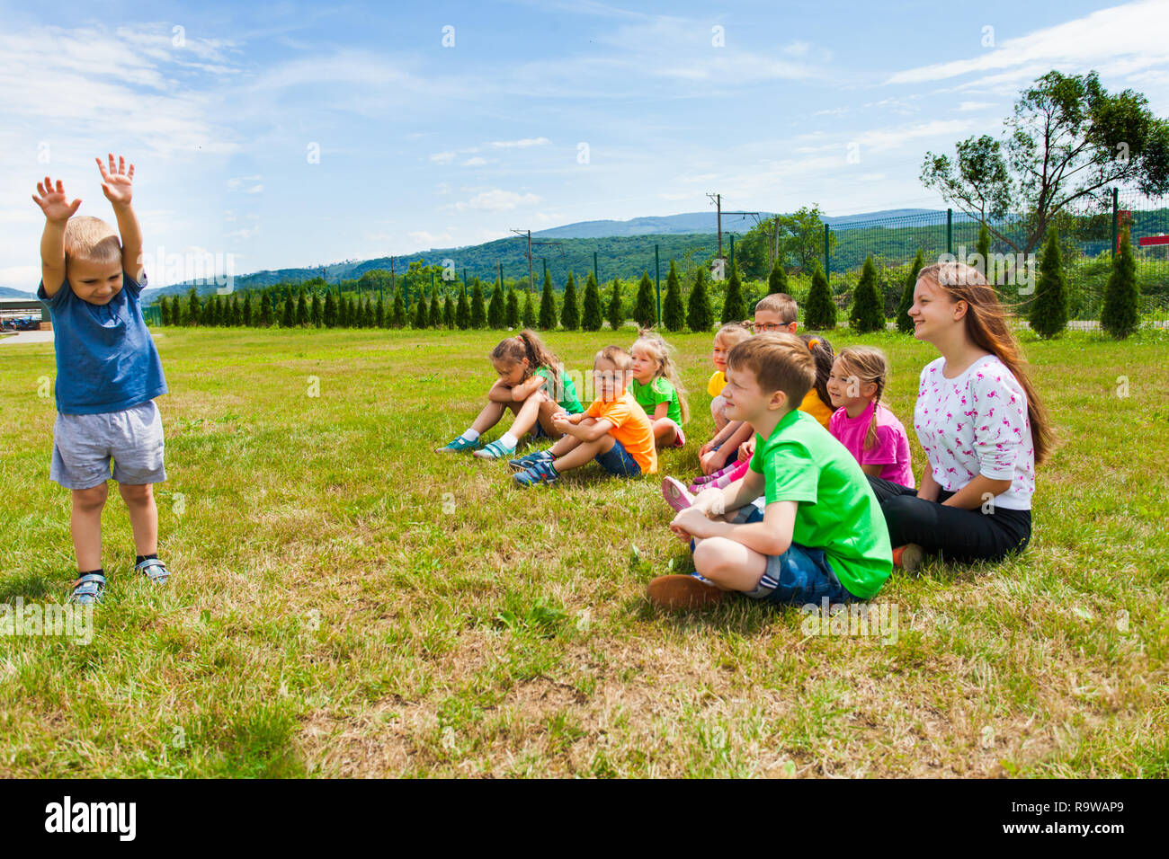 Lovely boy standing in front of group of kids Stock Photo - Alamy