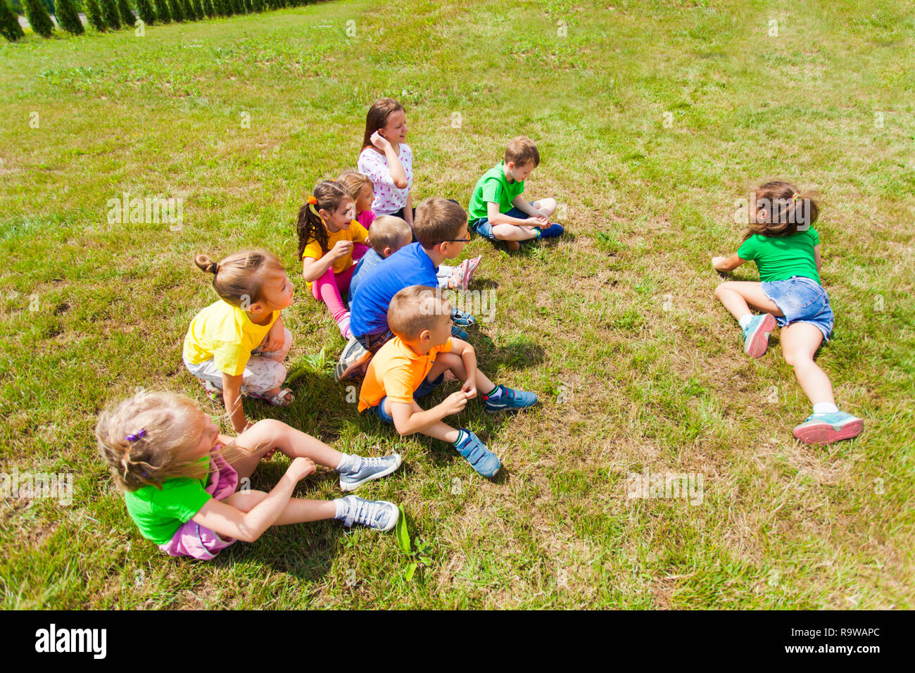 Top view of group of children playing on grass Stock Photo - Alamy