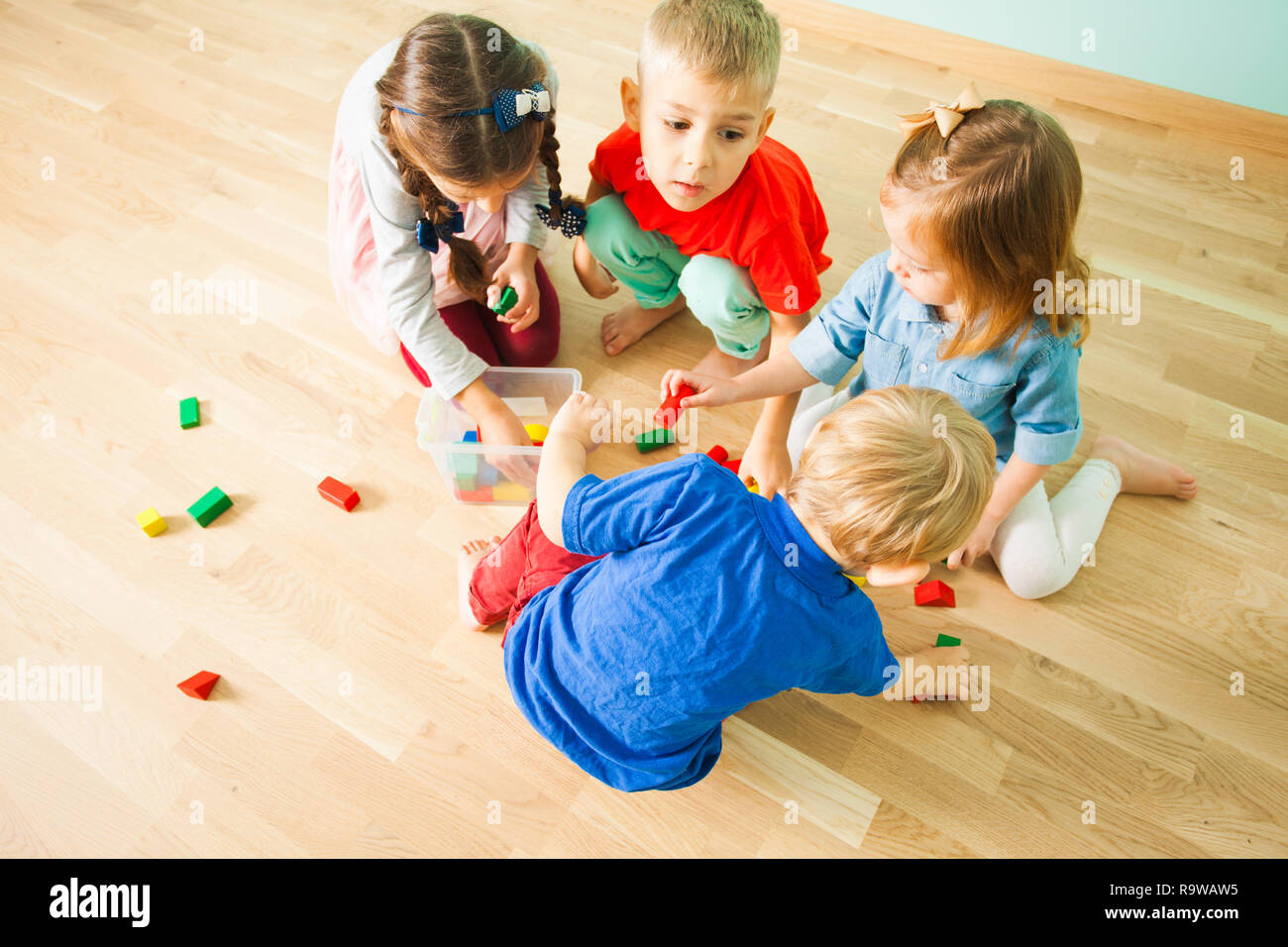 Top view kids cleaning a mess in children room Stock Photo - Alamy