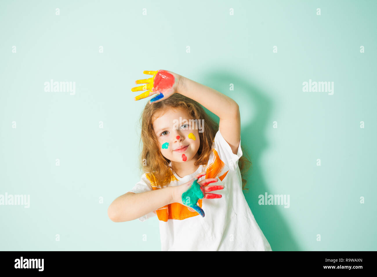 Adorable girl with colorful dots on her face Stock Photo - Alamy