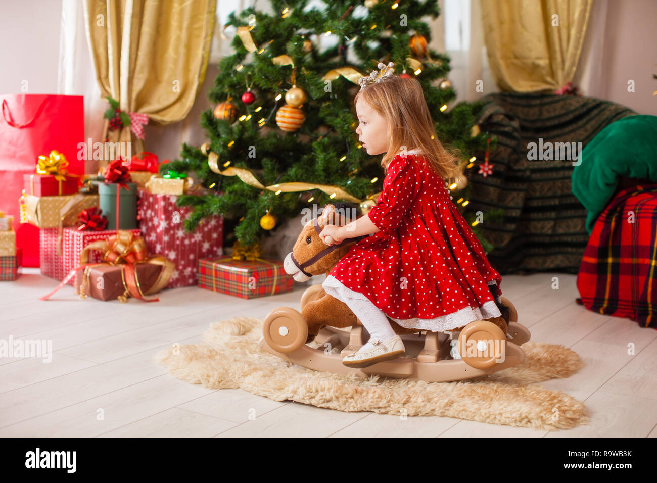 Little girl swings on the rocking hors Stock Photo - Alamy