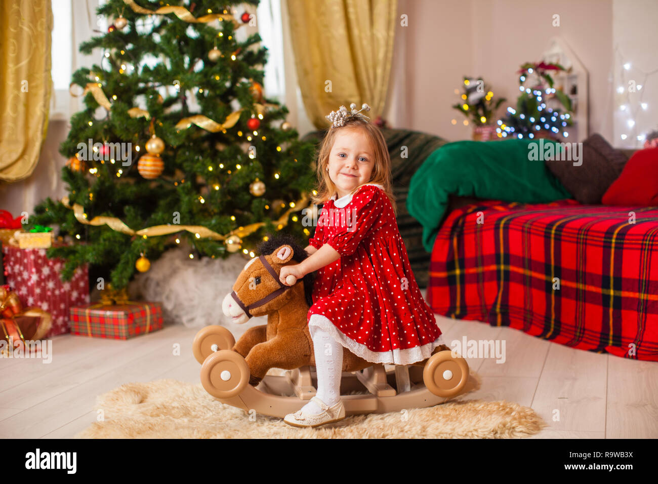 Little girl swings on the rocking hors Stock Photo - Alamy