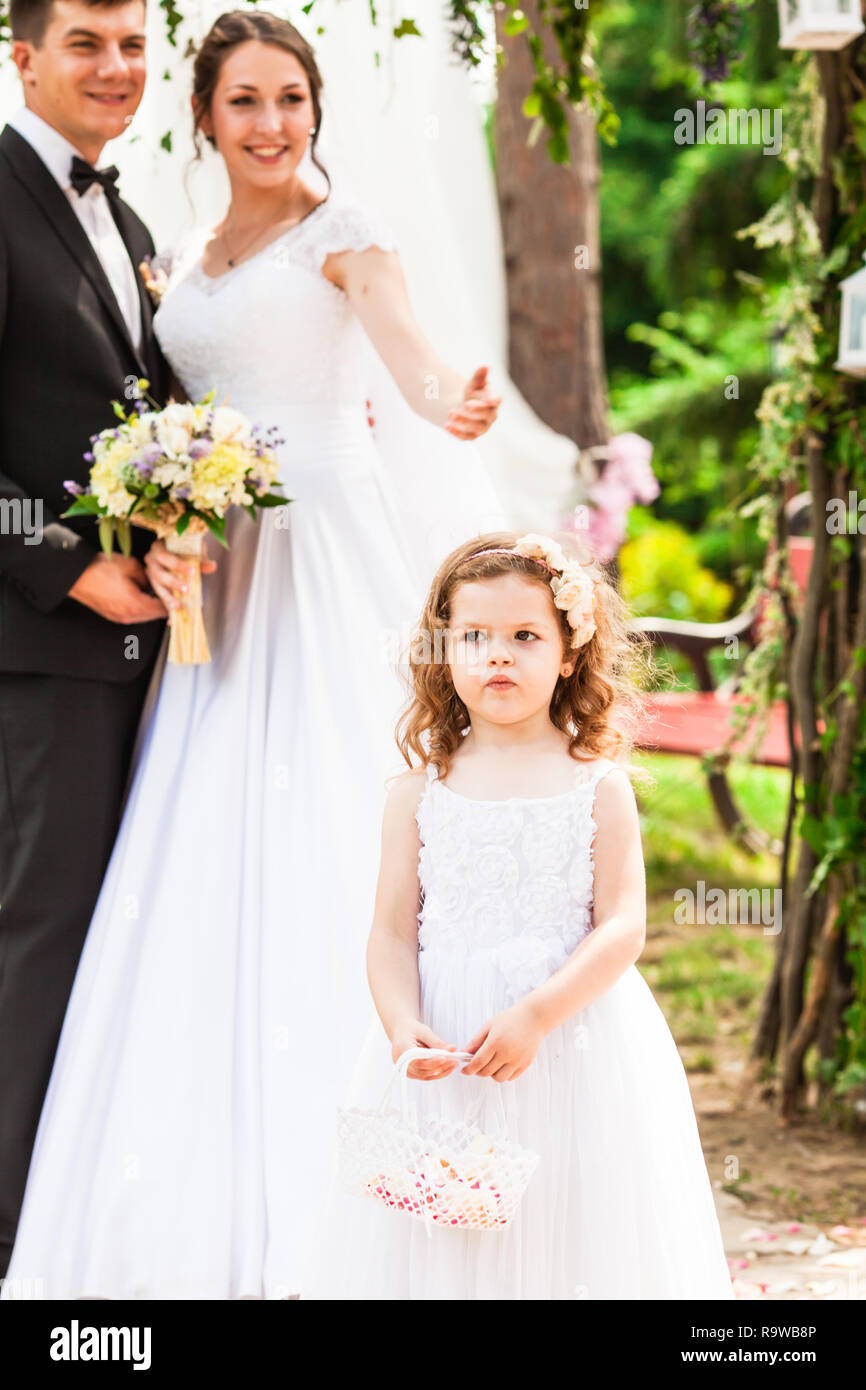 The little girl and wedding couple on ceremony Stock Photo - Alamy