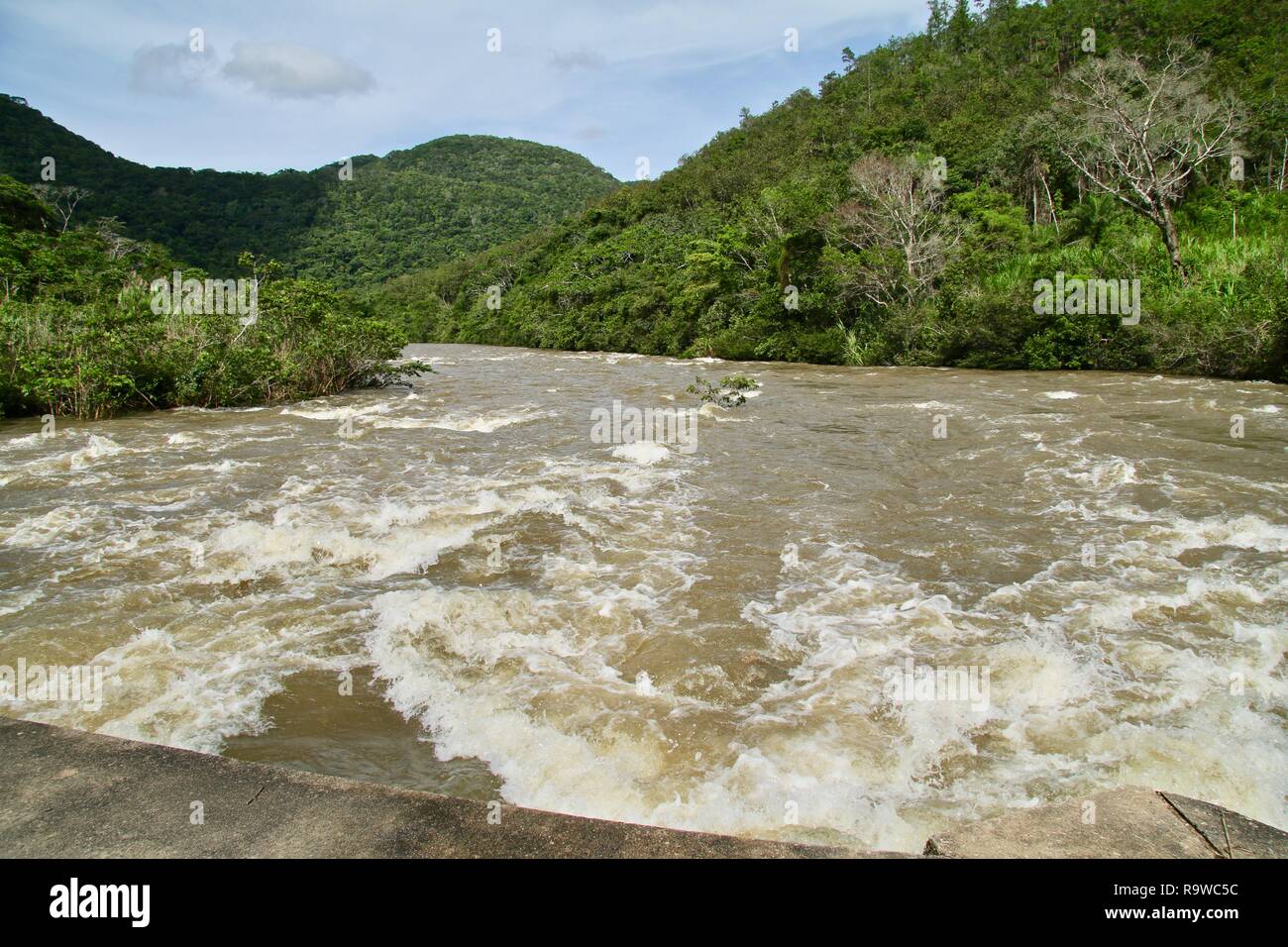 A remote river in full flow during a storm Stock Photo - Alamy