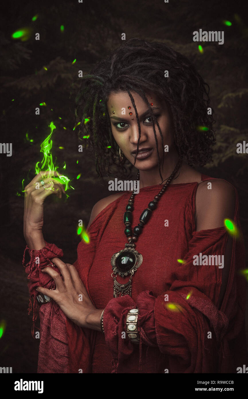 Woman with hairstyle dreadlocks and red clothes and green fire from her ...