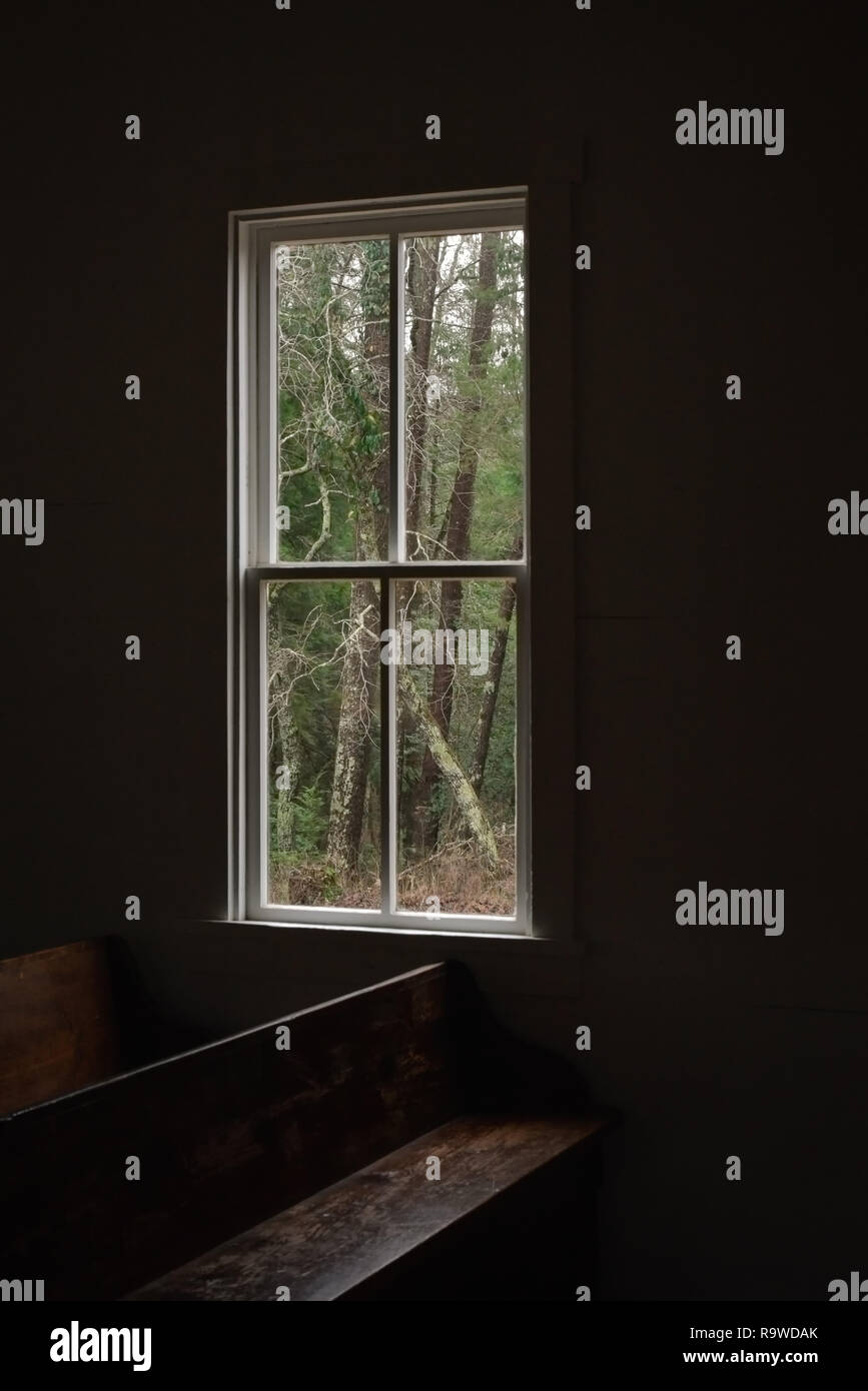 Nostalgic scene of an abandoned lonely old country church with a window ...