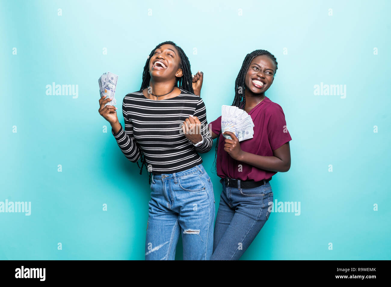 Photo of african american womens win scream with dollar banknotes ...