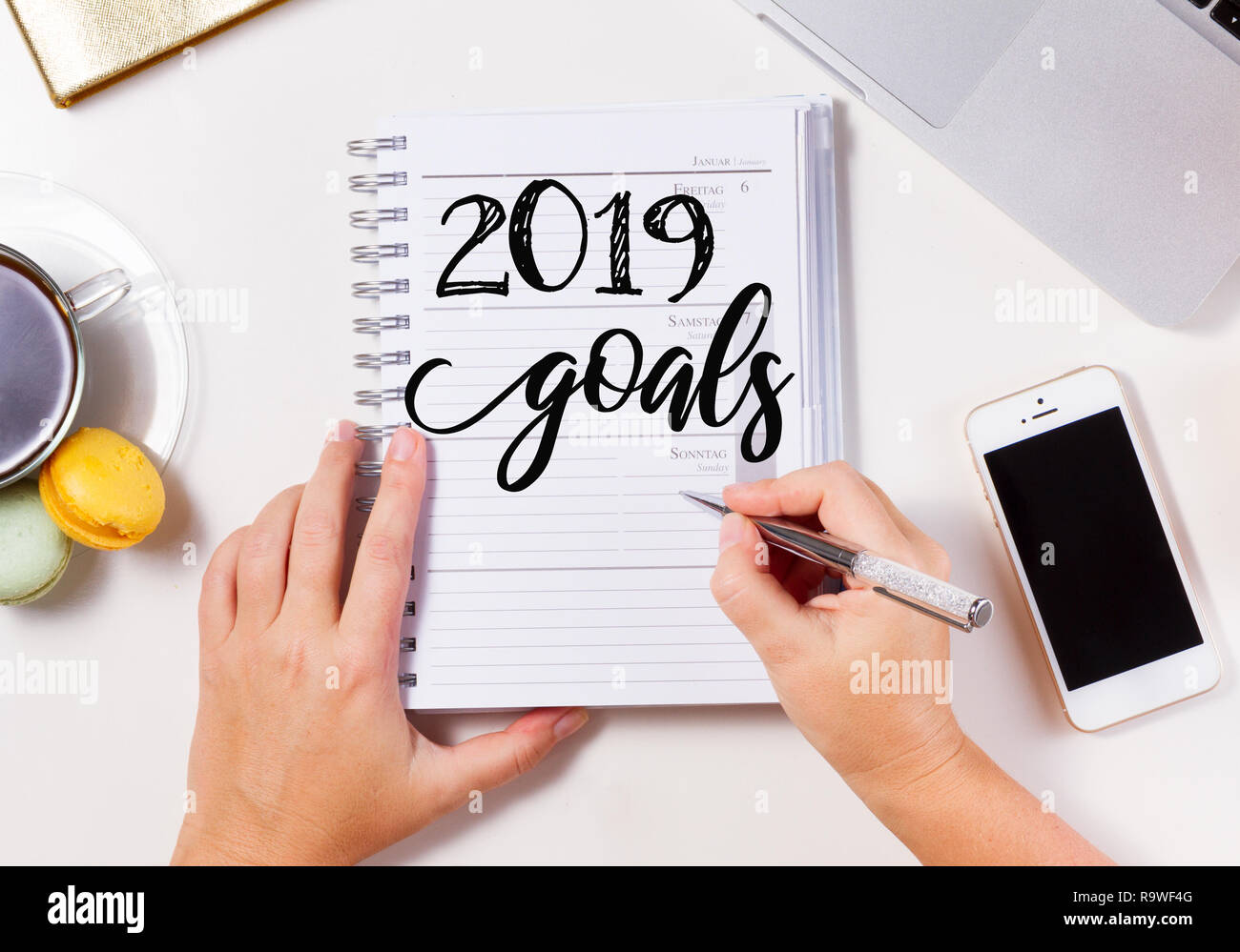 Top view 2019 goals list with feminine workspace with empty ruled ...