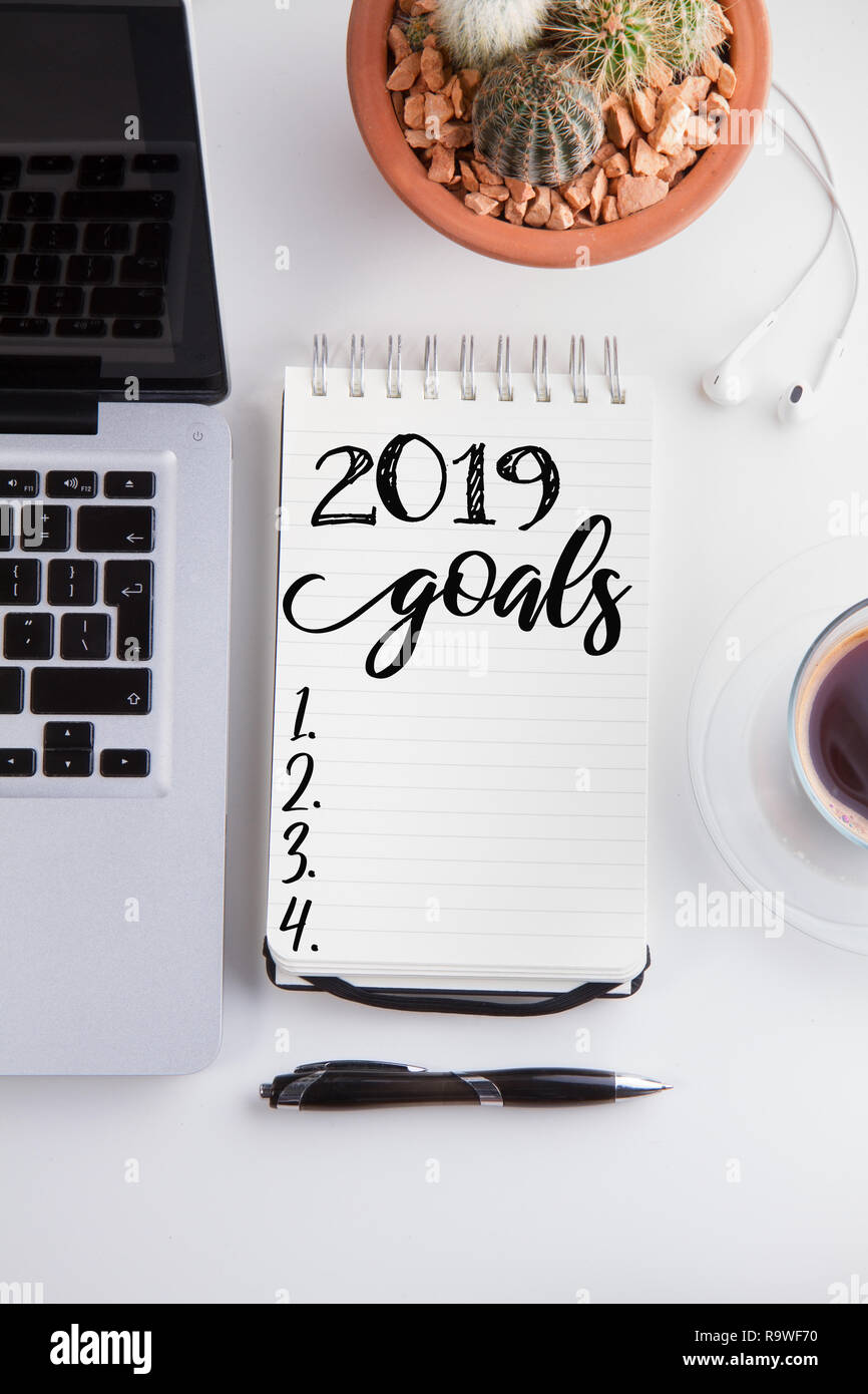 Top view 2019 goals list with styled workspace with empty ruled ...