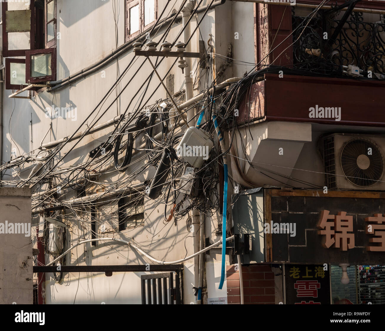 Electric and telephone cabling on building walls in Shanghai China ...