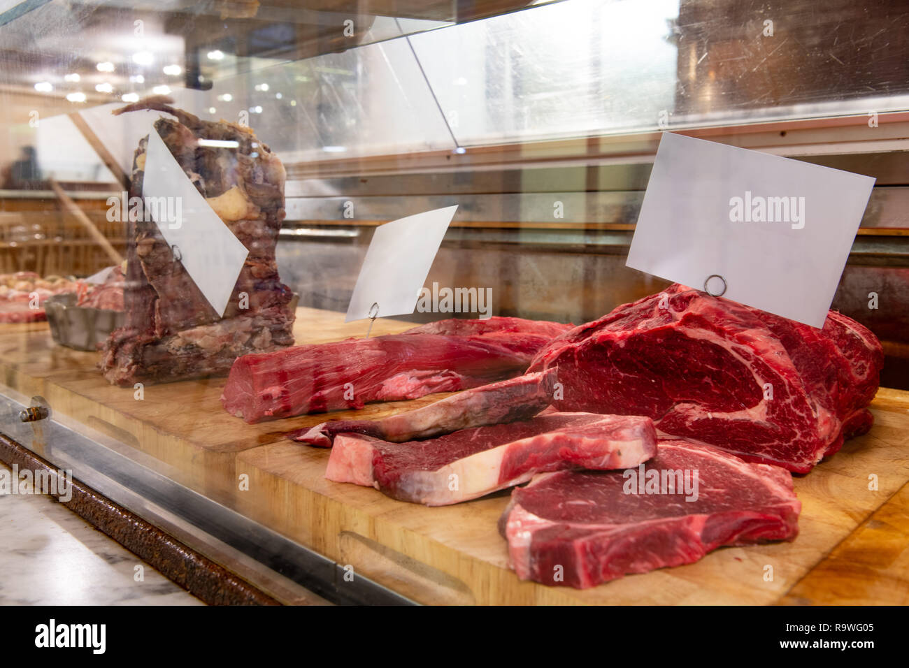 Side view of raw beef steak meat in butcher shop stall, copy space on ...