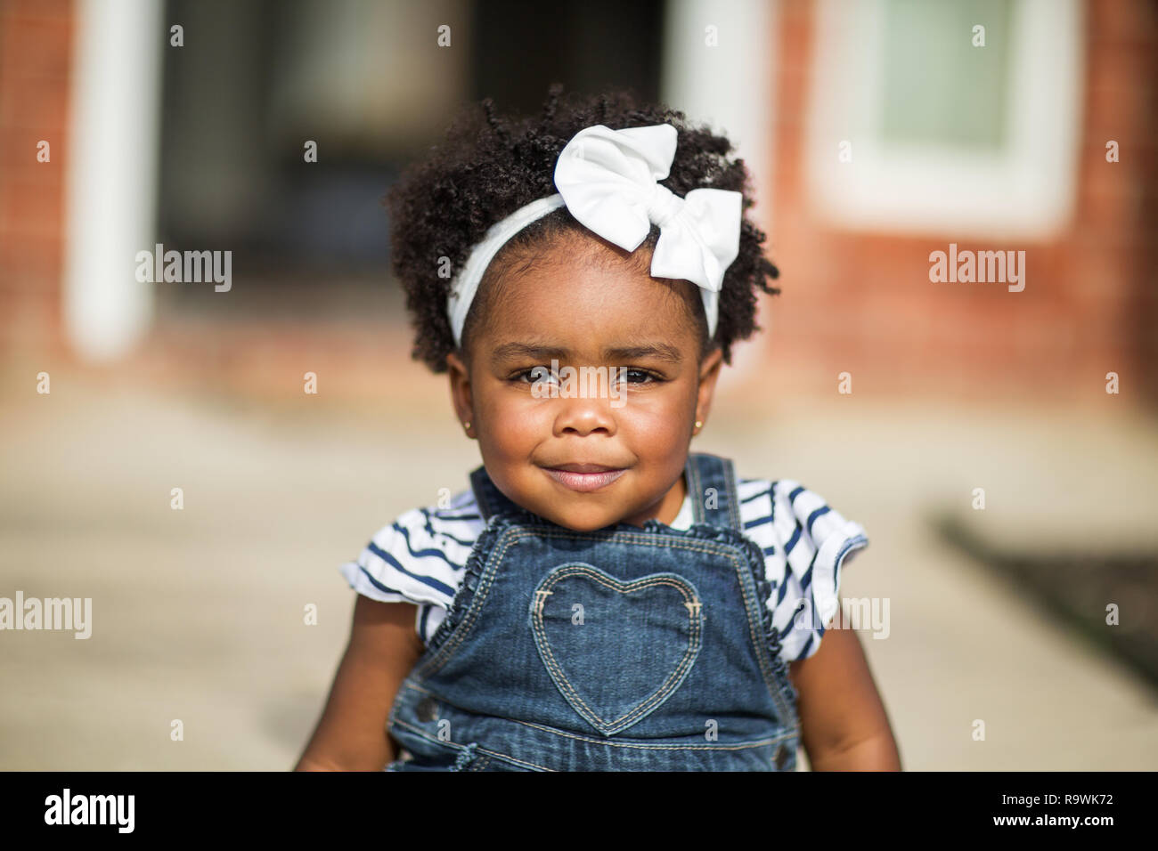 Happy little girl laughing and smiling outside Stock Photo - Alamy