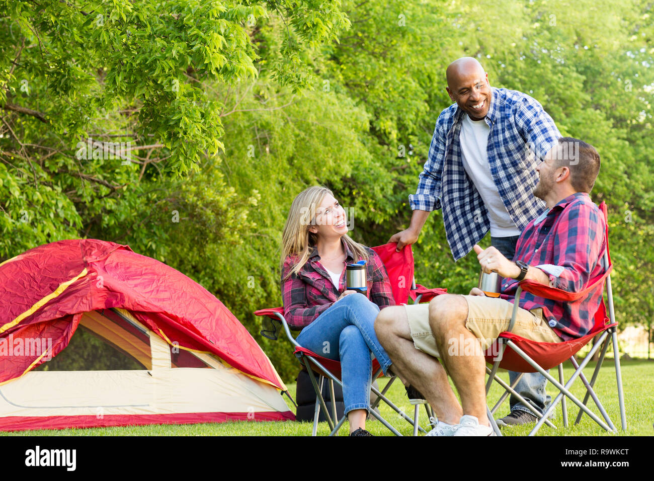 Multi-ethnic group of friends laughing and talking Stock Photo - Alamy
