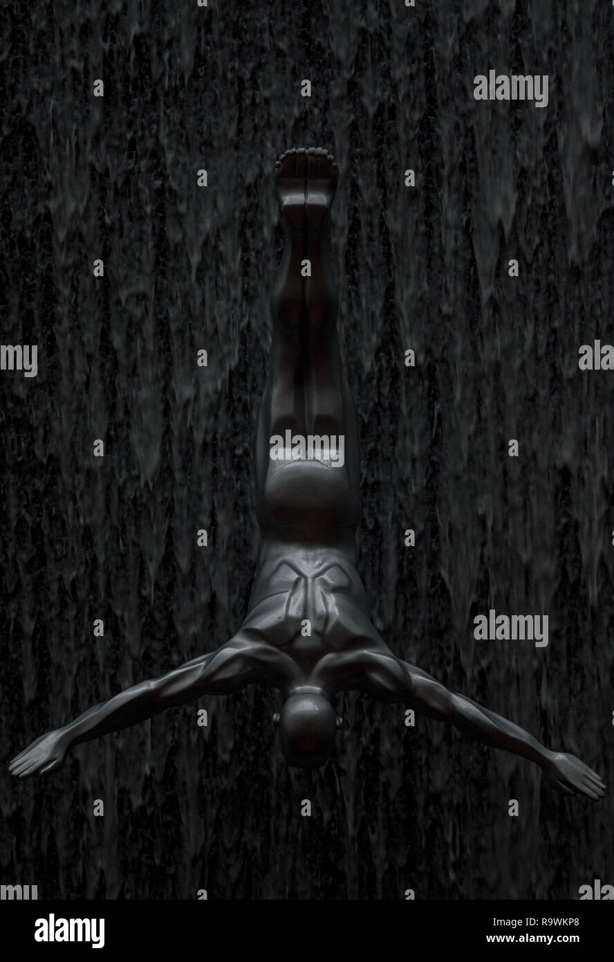 A statue of a diving man in the waterfall in the Dubai Mall, Dubai, UAE ...