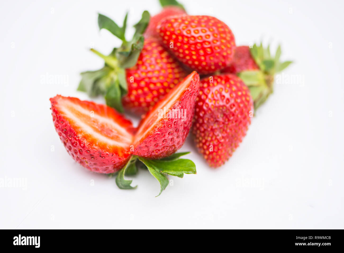 Isolated fresh half cut strawberry Stock Photo - Alamy