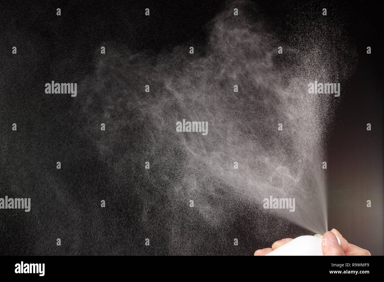 a trace sprayed with spray in a black background Stock Photo - Alamy