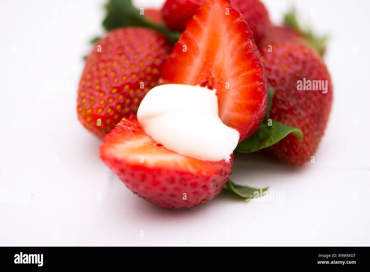 Isolated fresh half cut strawberry Stock Photo - Alamy