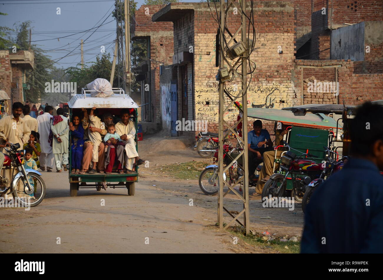 A motorcycle rikshaw or tukuk with people sitting in it. A view from ...