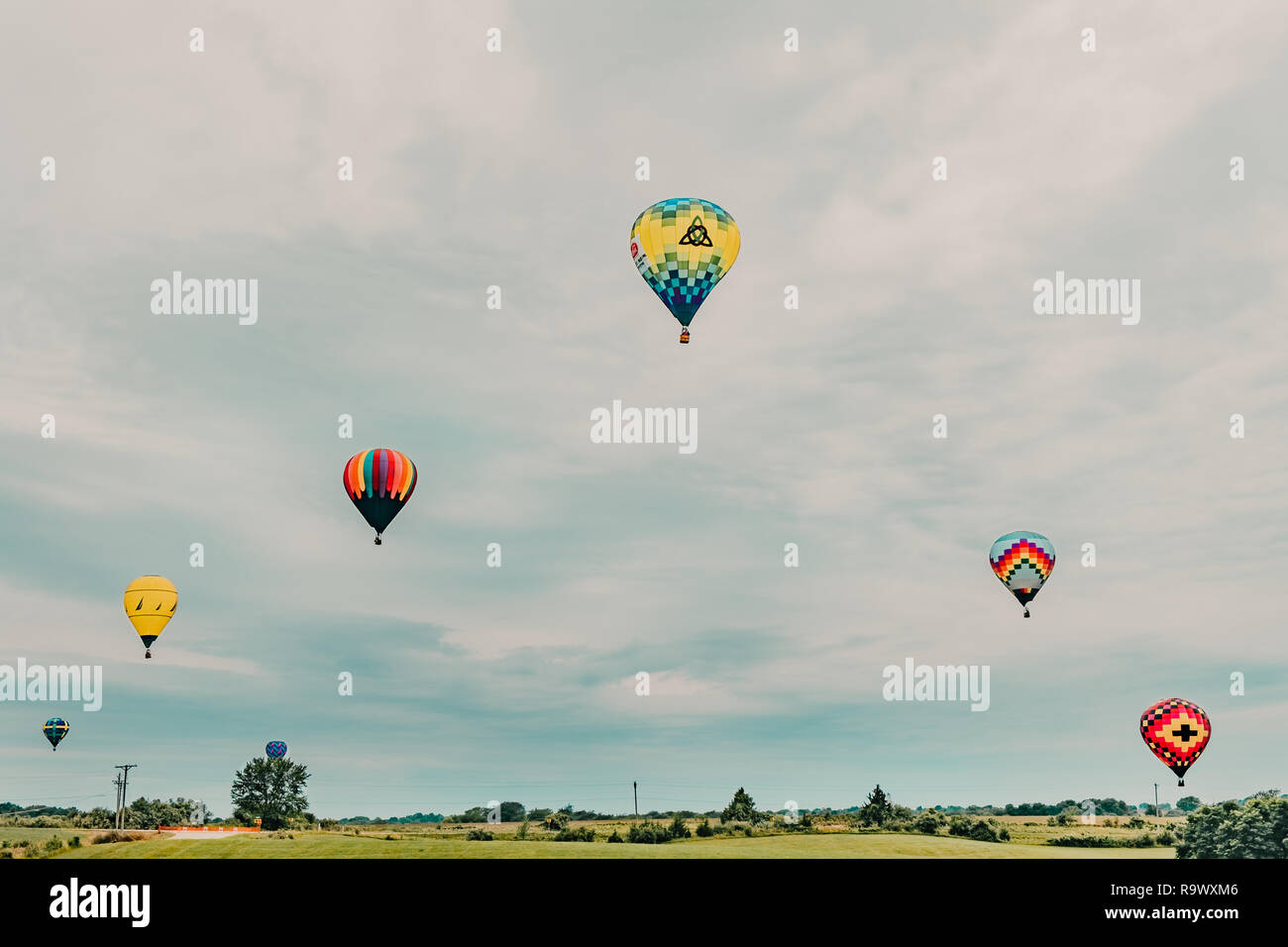 Hot air balloons take flight during sunrise at a hot air balloon ...
