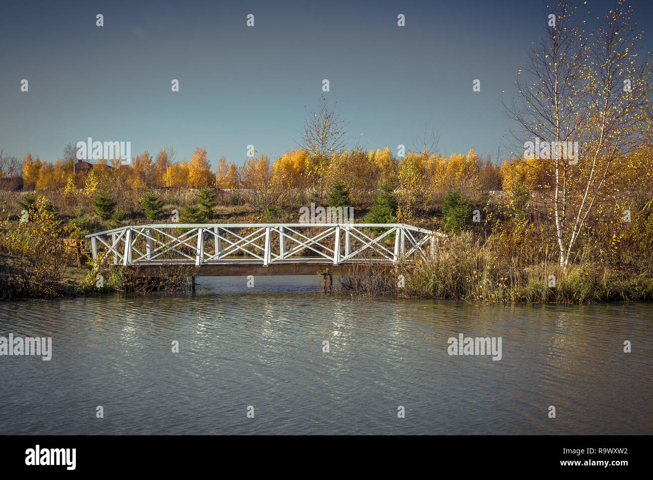 A wooden bridge across the river Stock Photo - Alamy