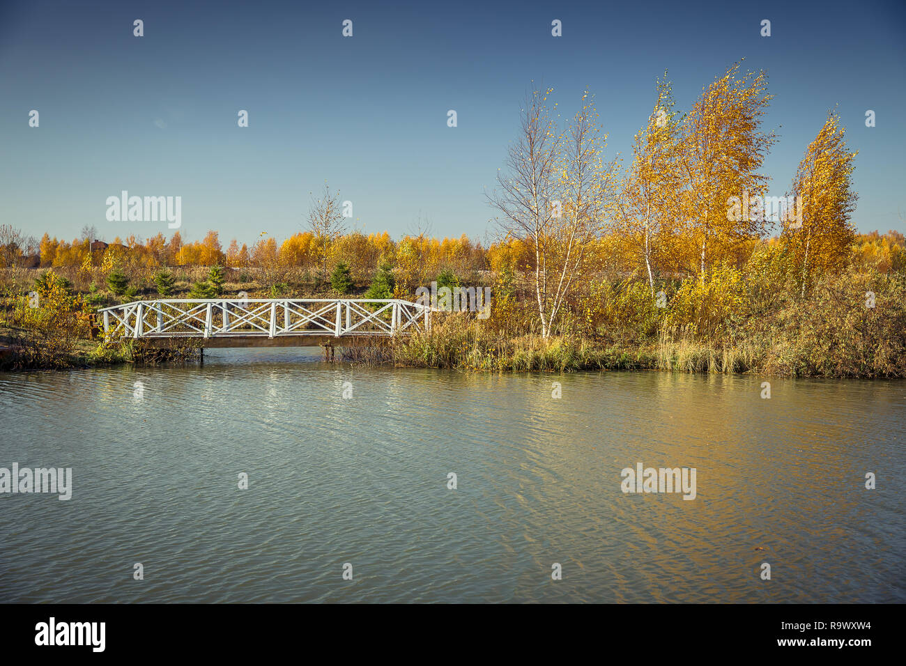 A wooden bridge across the river Stock Photo - Alamy