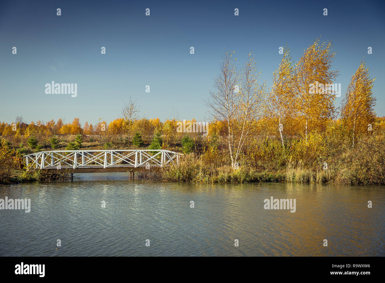 A wooden bridge across the river Stock Photo - Alamy