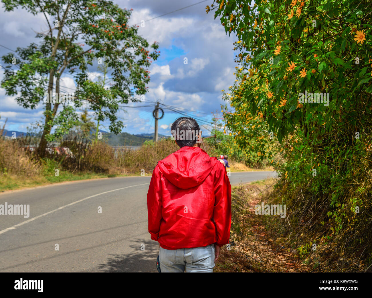An Asian young man walking on rural road in Dalat, Vietnam Stock Photo ...