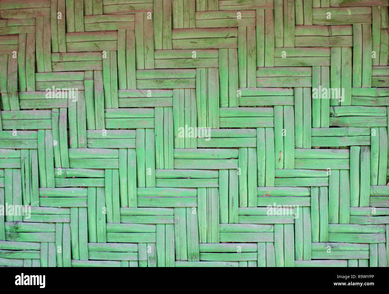 Texture of the old wicker mat of bamboo green color Stock Photo - Alamy