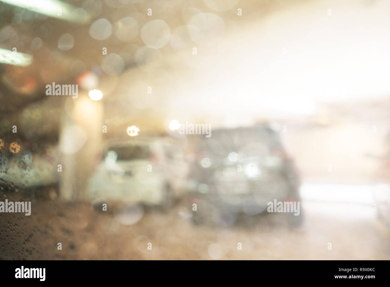 Blurred bokeh view inside shopping mall parking lot in raining day ...