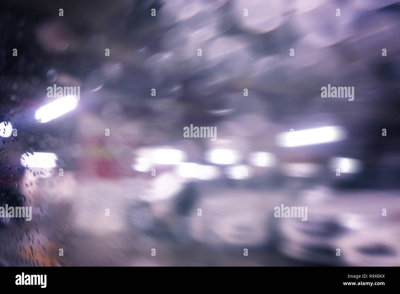 Blurred bokeh view inside shopping mall parking lot in raining day ...
