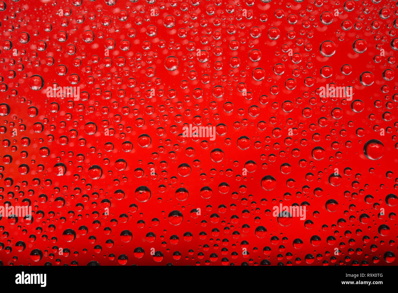 Water drops on red background, close up Stock Photo - Alamy
